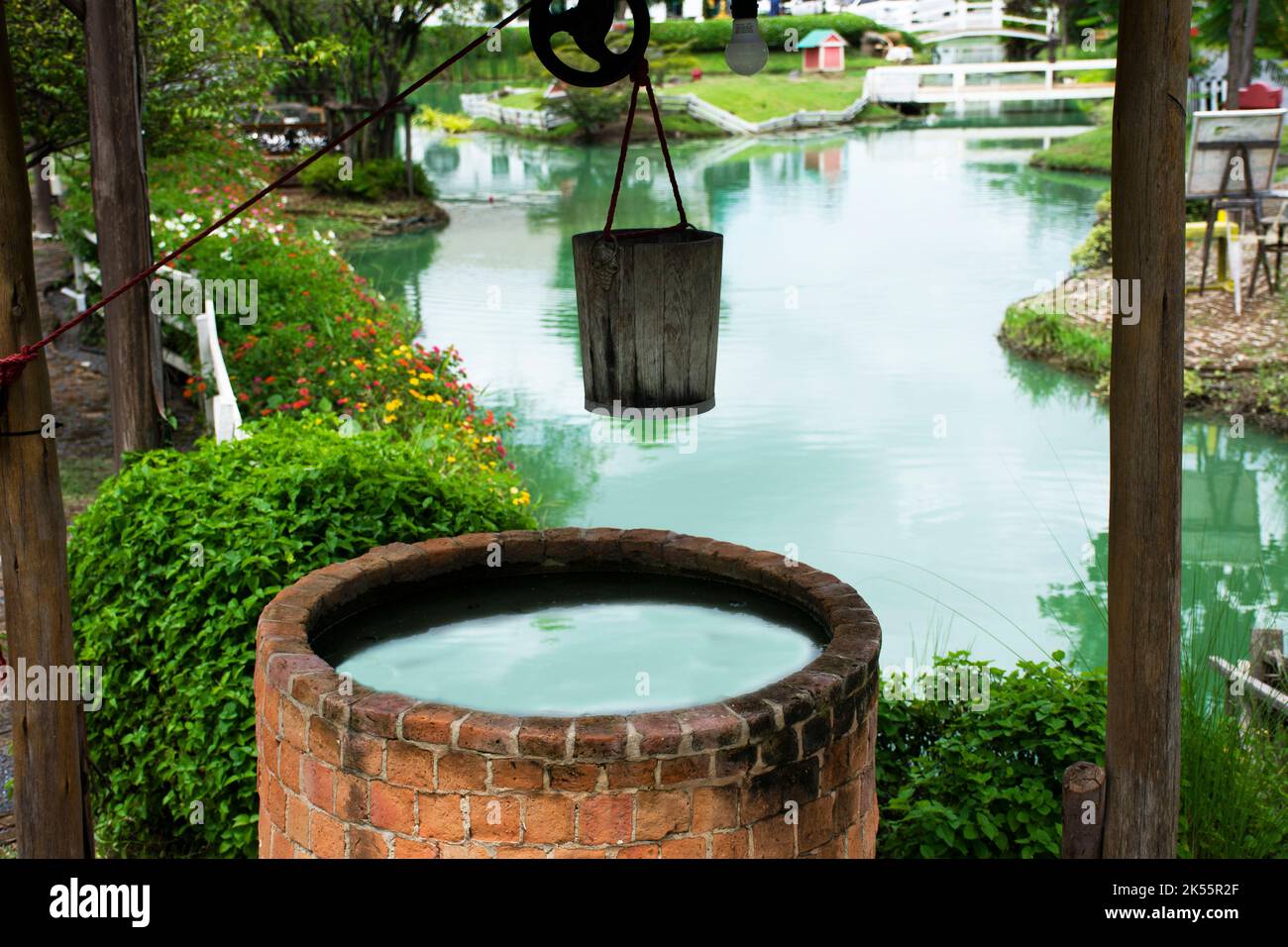 Classic vintage retro antique stone brick artesian water well and roof ...