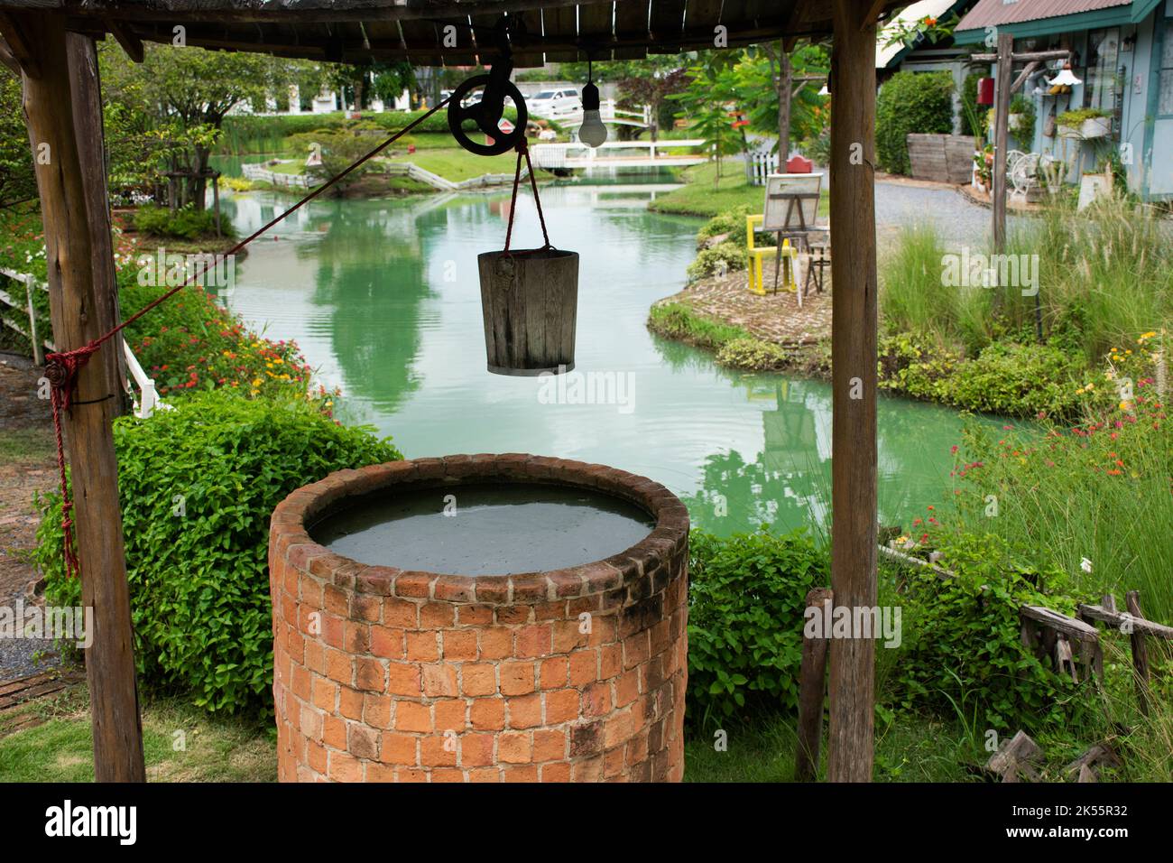 Classic vintage retro antique stone brick artesian water well and roof ...