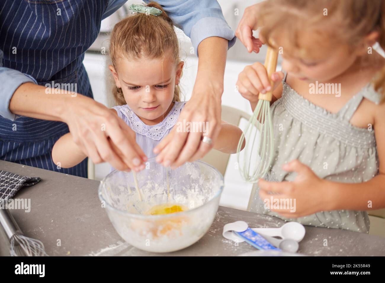 Cooking, girls or bonding mother helping with eggs for dessert ...