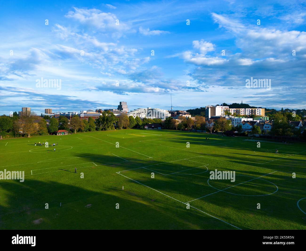 The view of the green football field and blue cloudy sky. Harrow ...