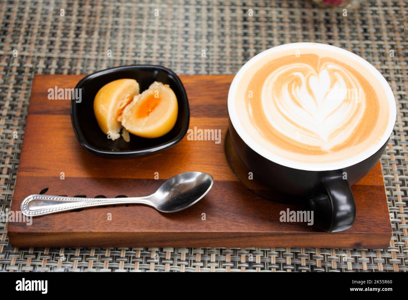 Hot coffee latte art serve with chinese pastry moon cake serve on ...