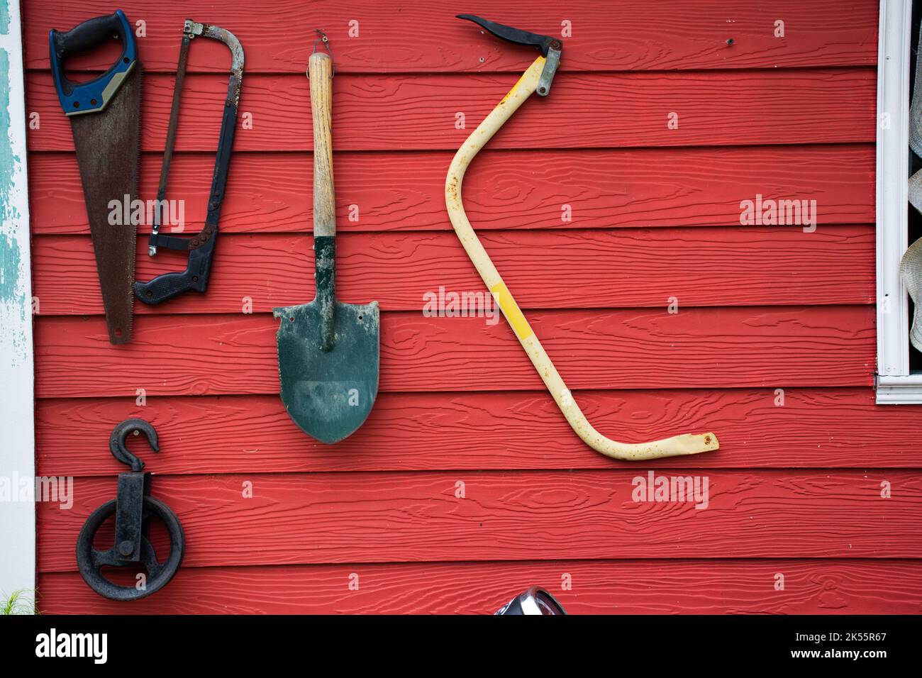 Tools and equipments farm gardening on red wooden wall of barn ...