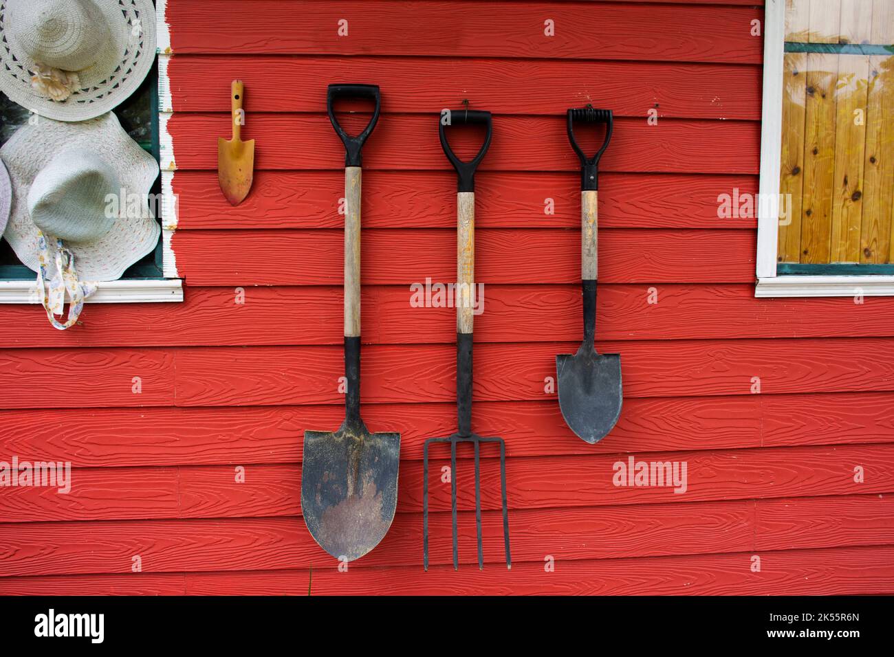 Tools and equipments farm gardening on red wooden wall of barn ...