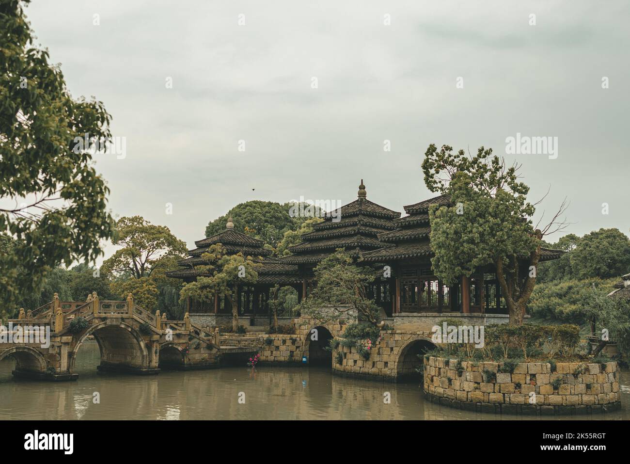 A historic Chinese temple on the pond with beautiful green yard Stock ...