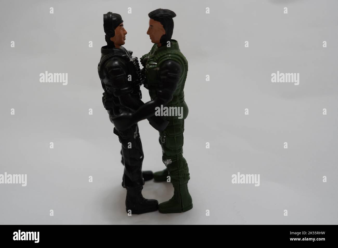 two soldier figurines arguing concept. armymen in green combat uniform ...