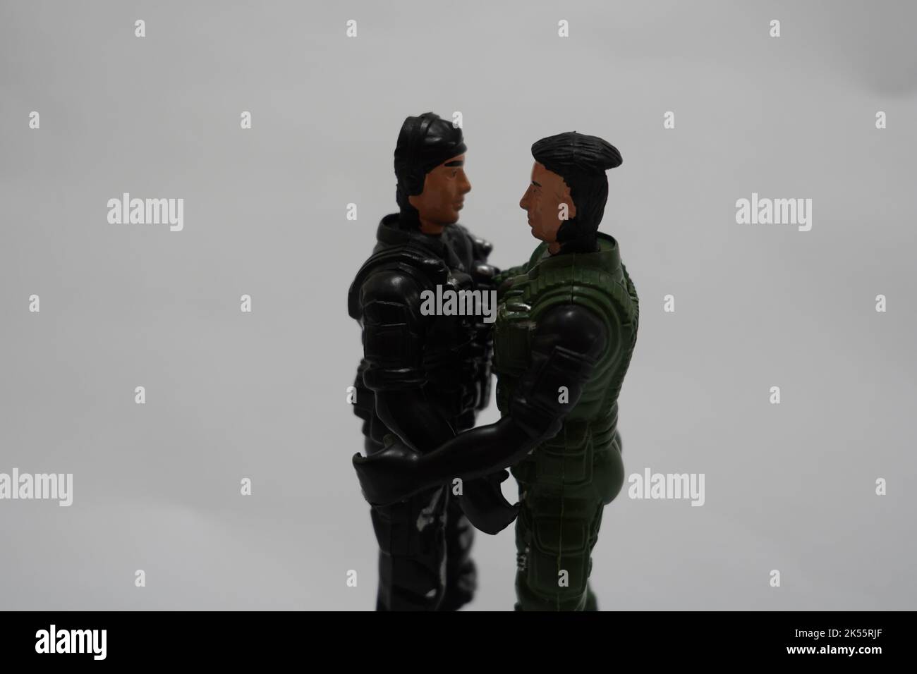two soldier figurines arguing concept. armymen in green combat uniform ...