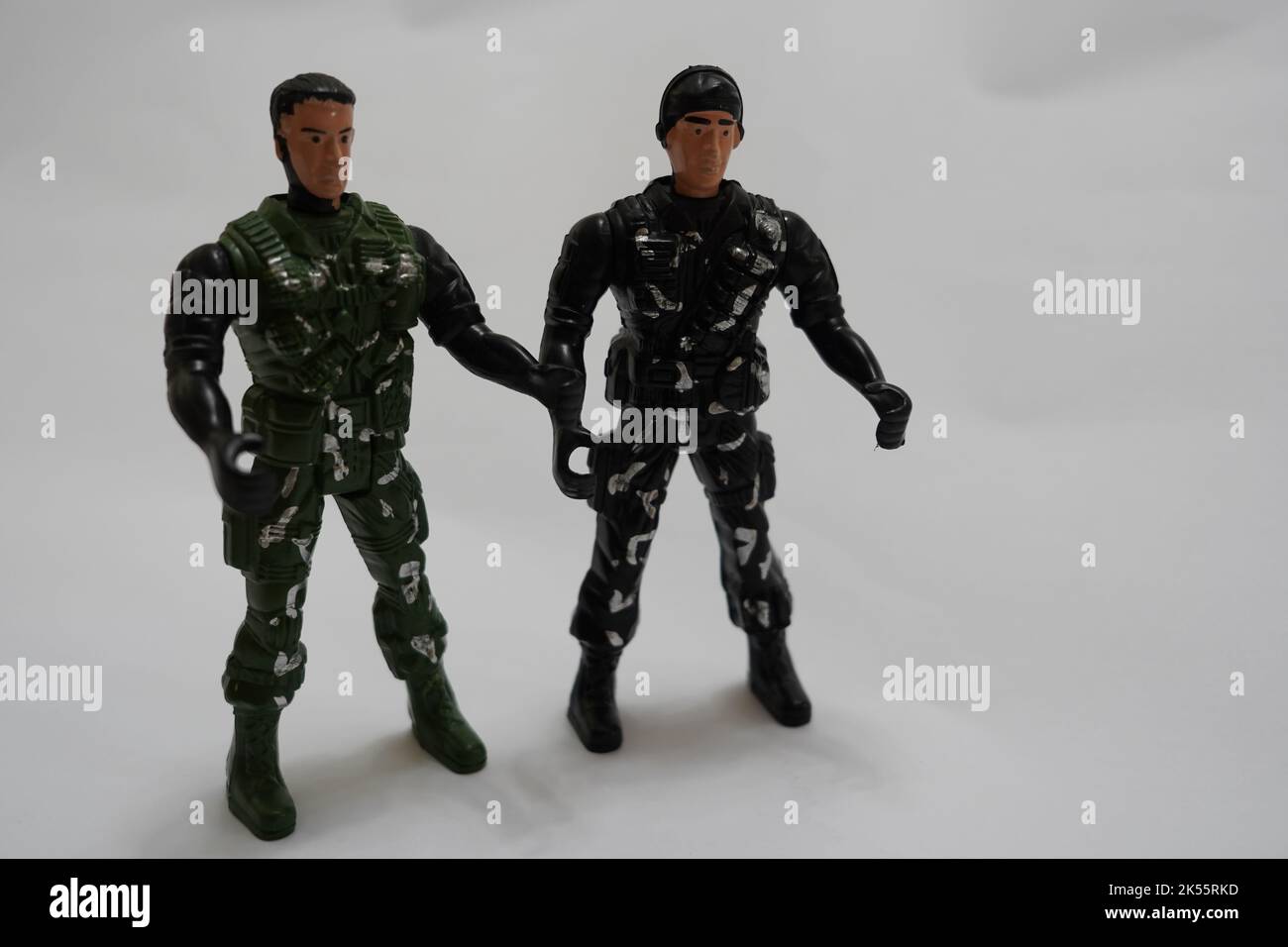 two soldier figurines arguing concept. armymen in green combat uniform ...