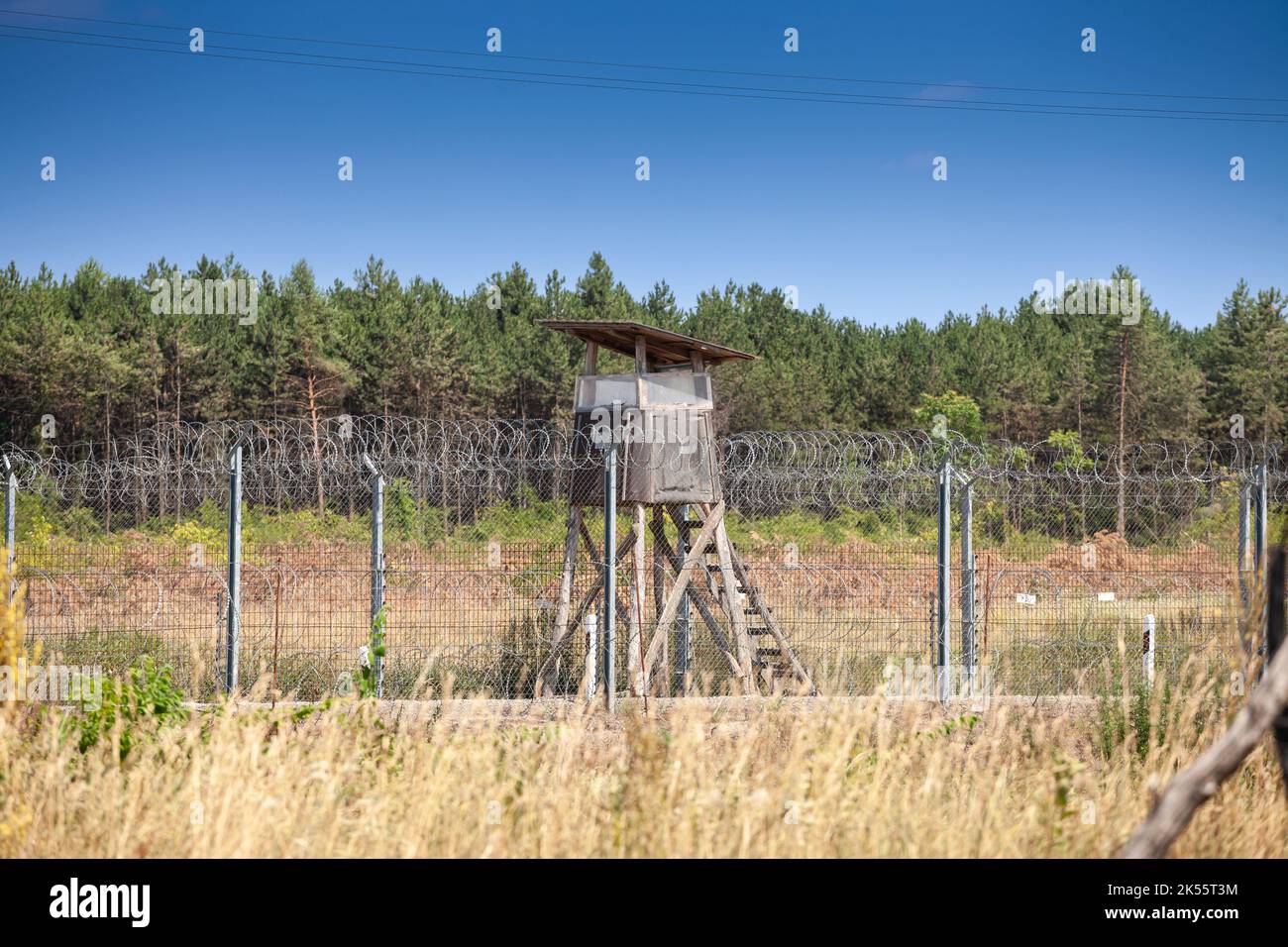 Picture of the Hungarian border wall with a watchtower overlooking the ...