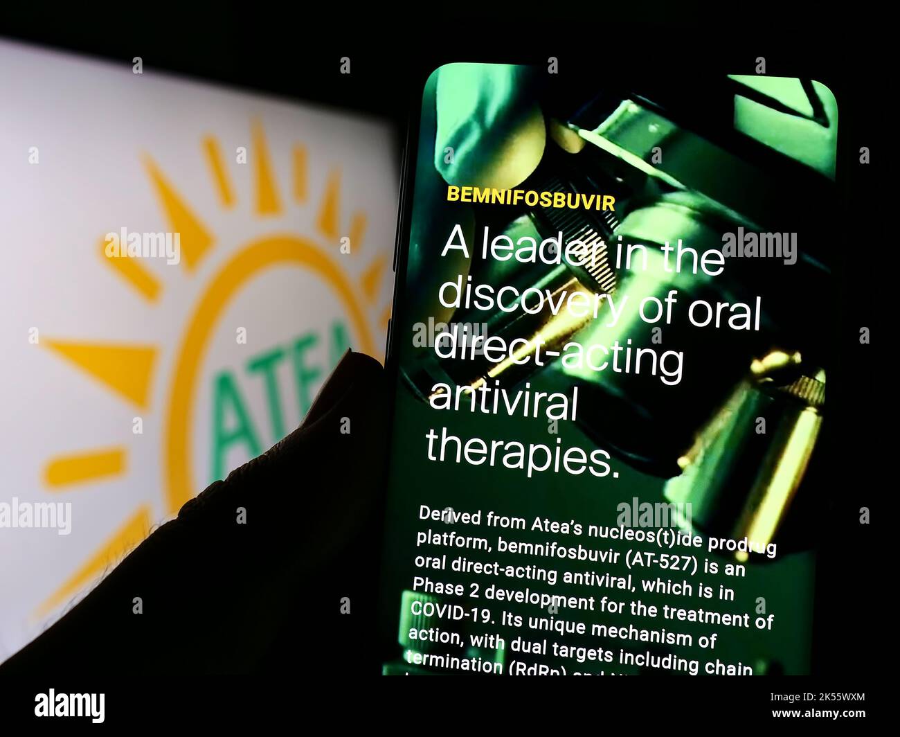 Person holding cellphone with website of US company Atea ...