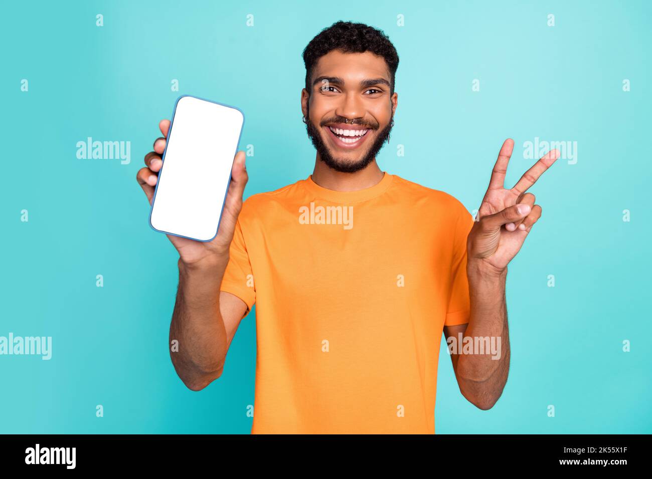Portrait of handsome positive guy demonstrate empty space telephone v ...