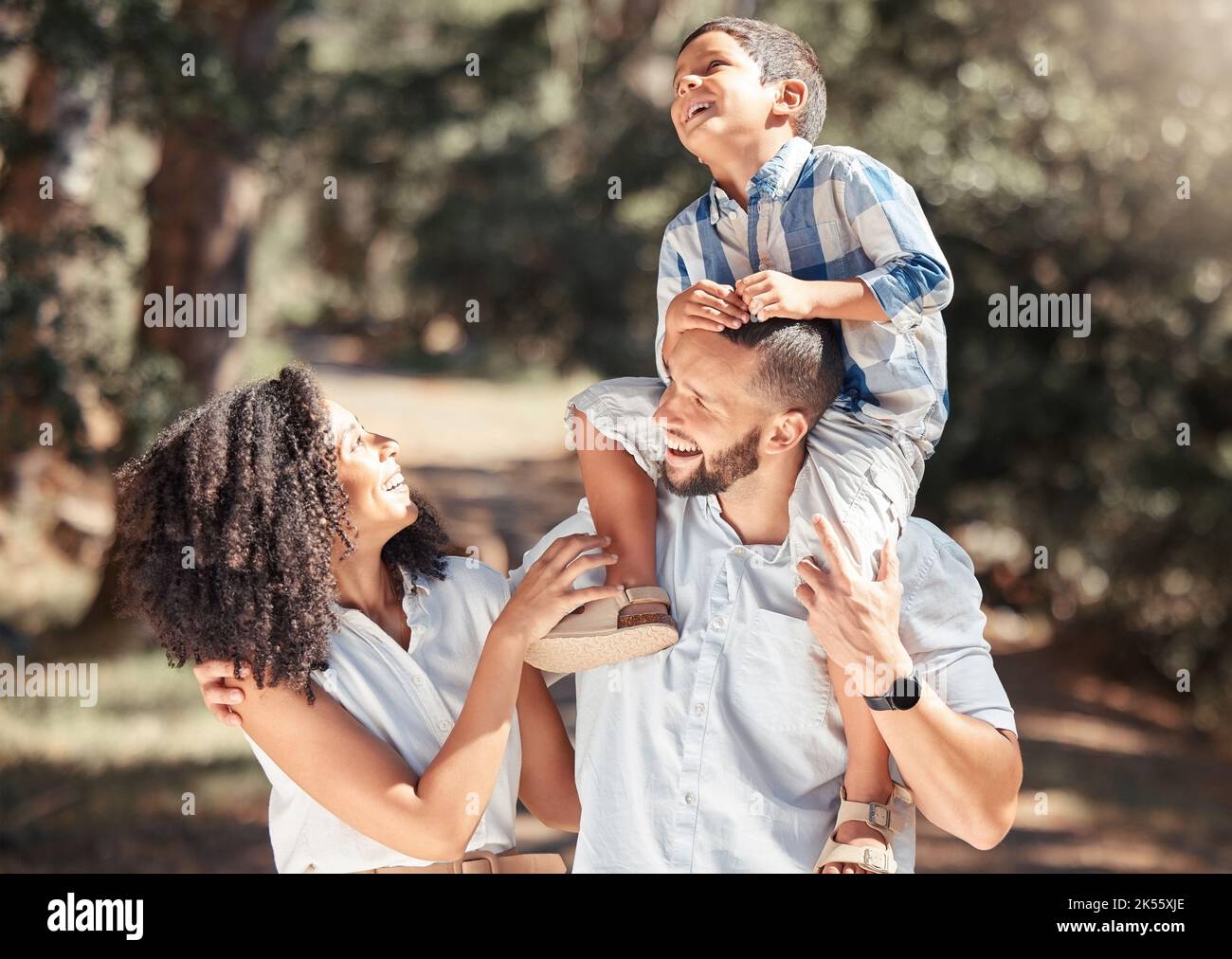 Love, relax and happy family laughing and bonding on outdoor walk in a park, cheerful and ...