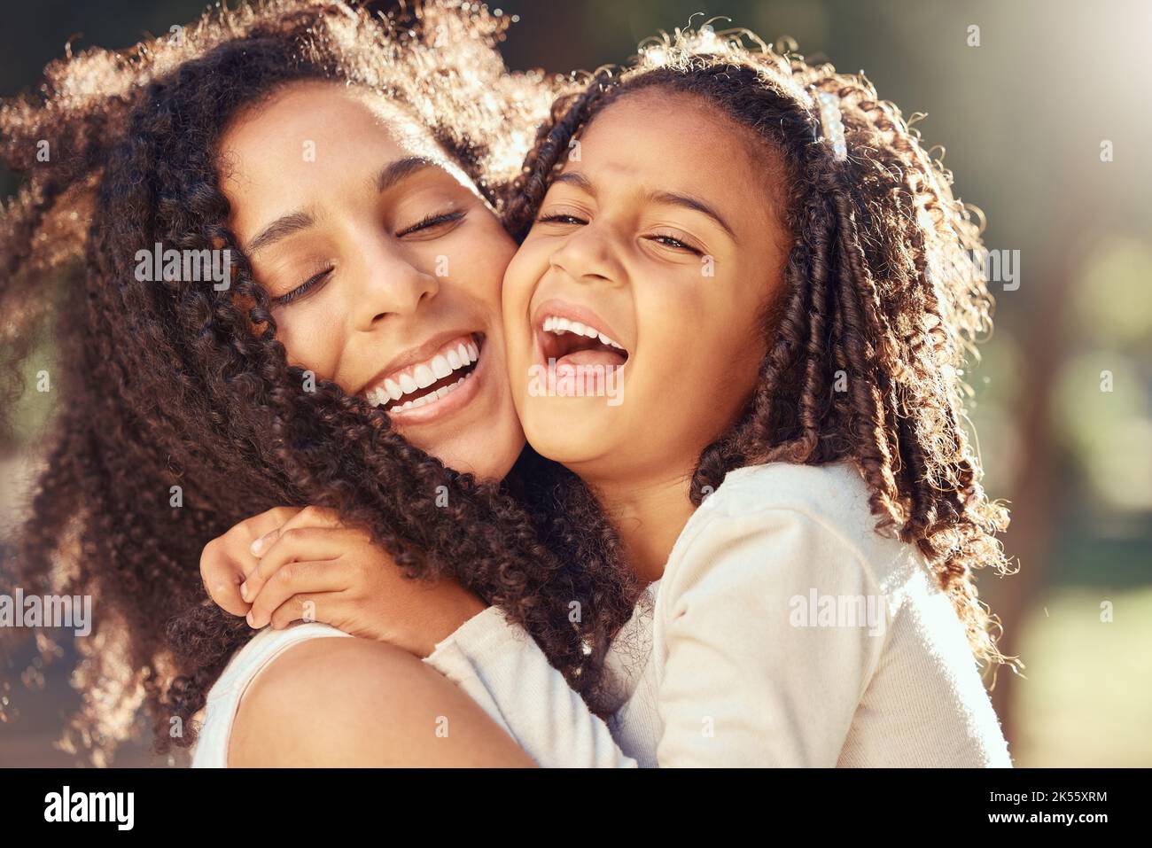 Happy girl kid hugging mom for mothers day, love and relax at park ...