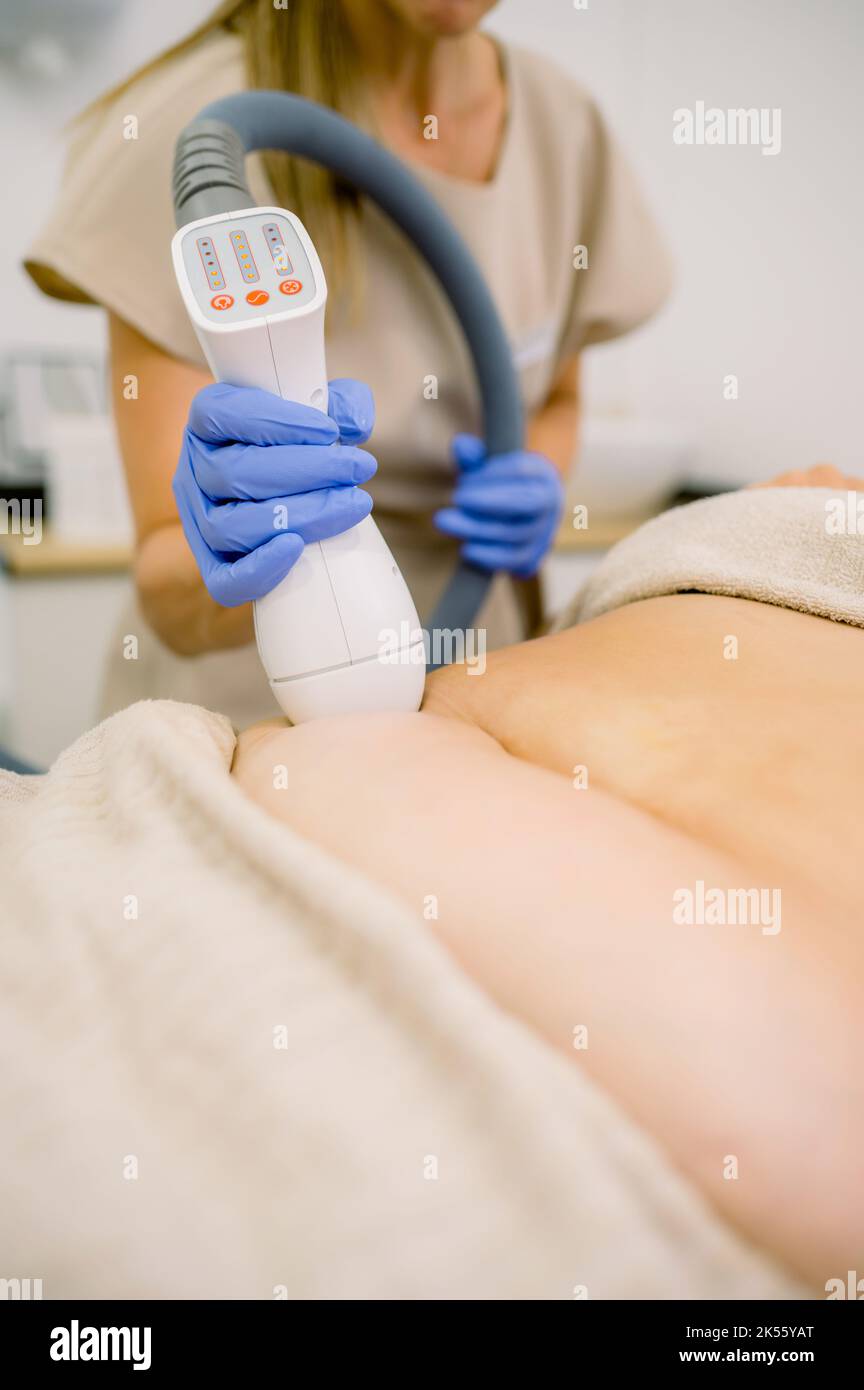 Woman giving fat reducing treatment Stock Photo - Alamy