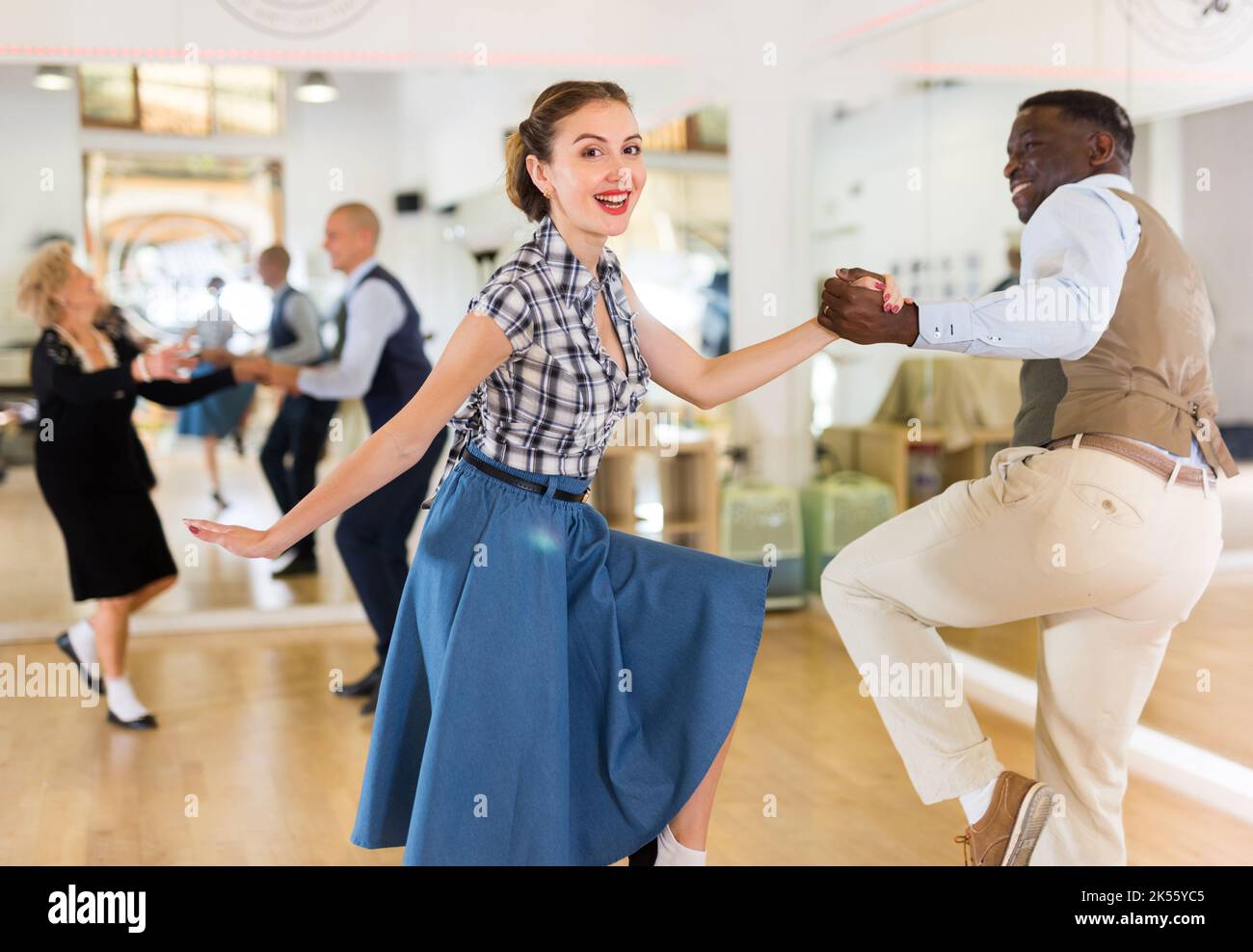 Man and woman performing jazz dance in dancing room Stock Photo - Alamy