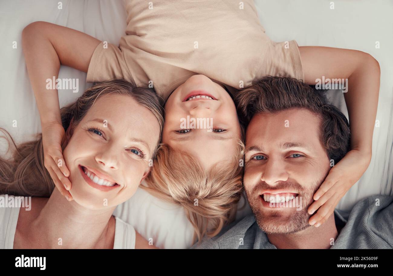 Love, relax and happy family in bed, resting and bonding in. a bedroom ...