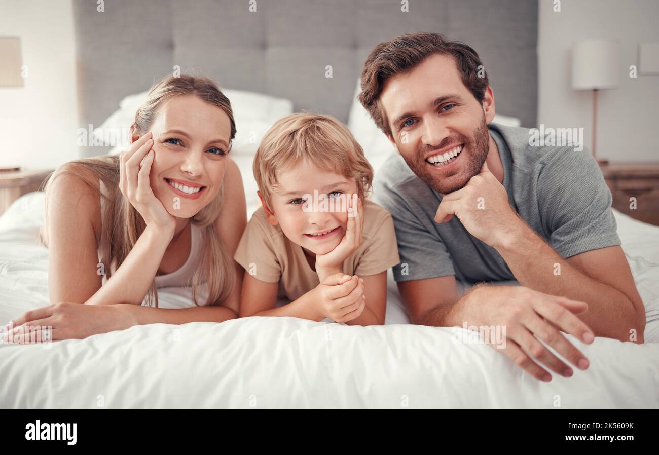 Love, bed and portrait of relax happy family with smile, happiness and ...
