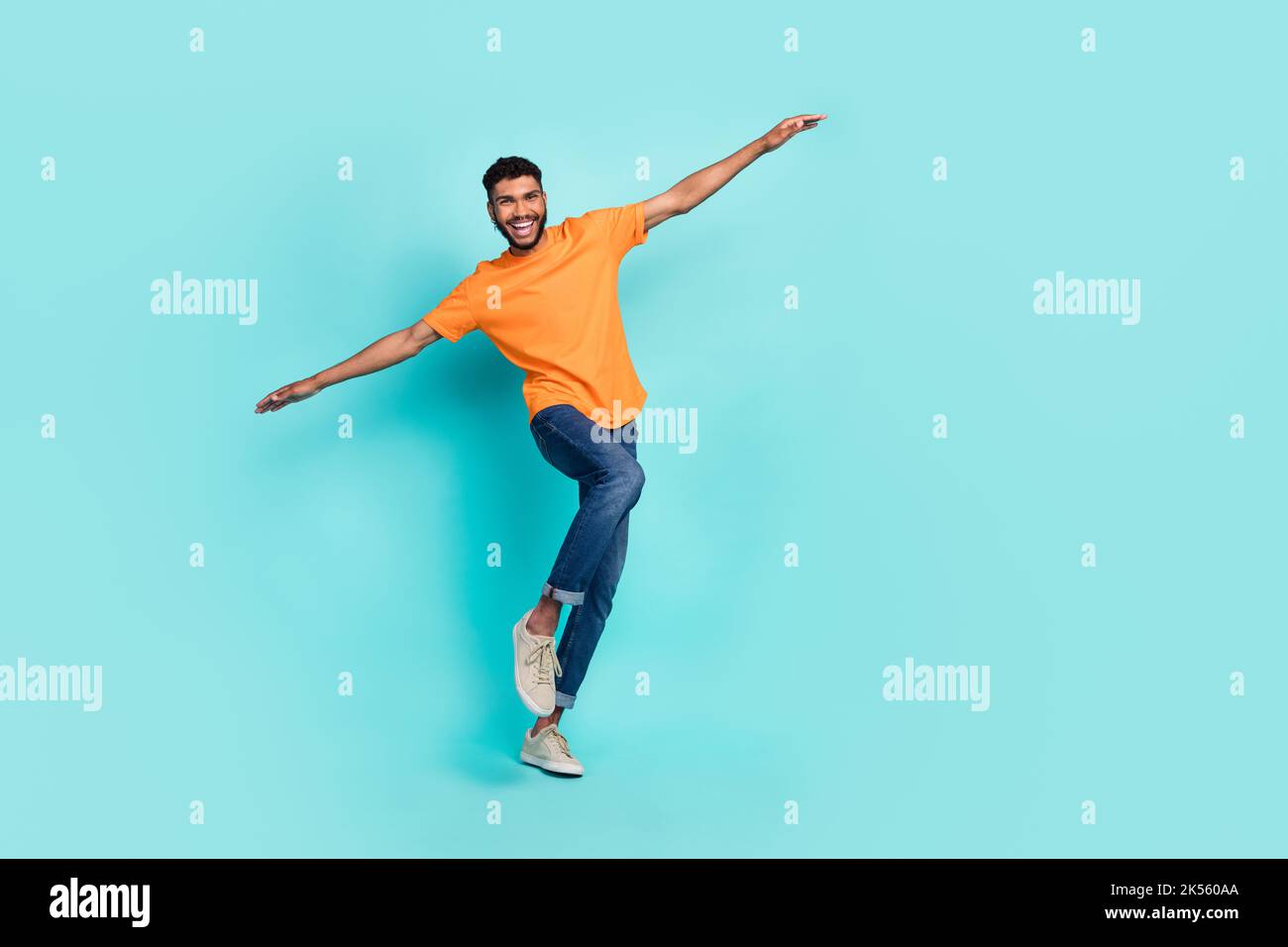 Full length photo of excited funky man dressed orange t-shirt smiling ...