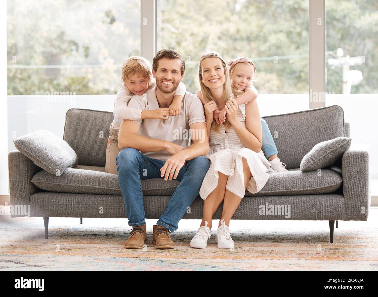 Happy, family smile and relax on living room sofa for holiday break ...