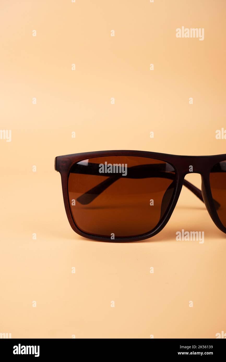 brown solar polarized safety glasses closeup on a beige background ...