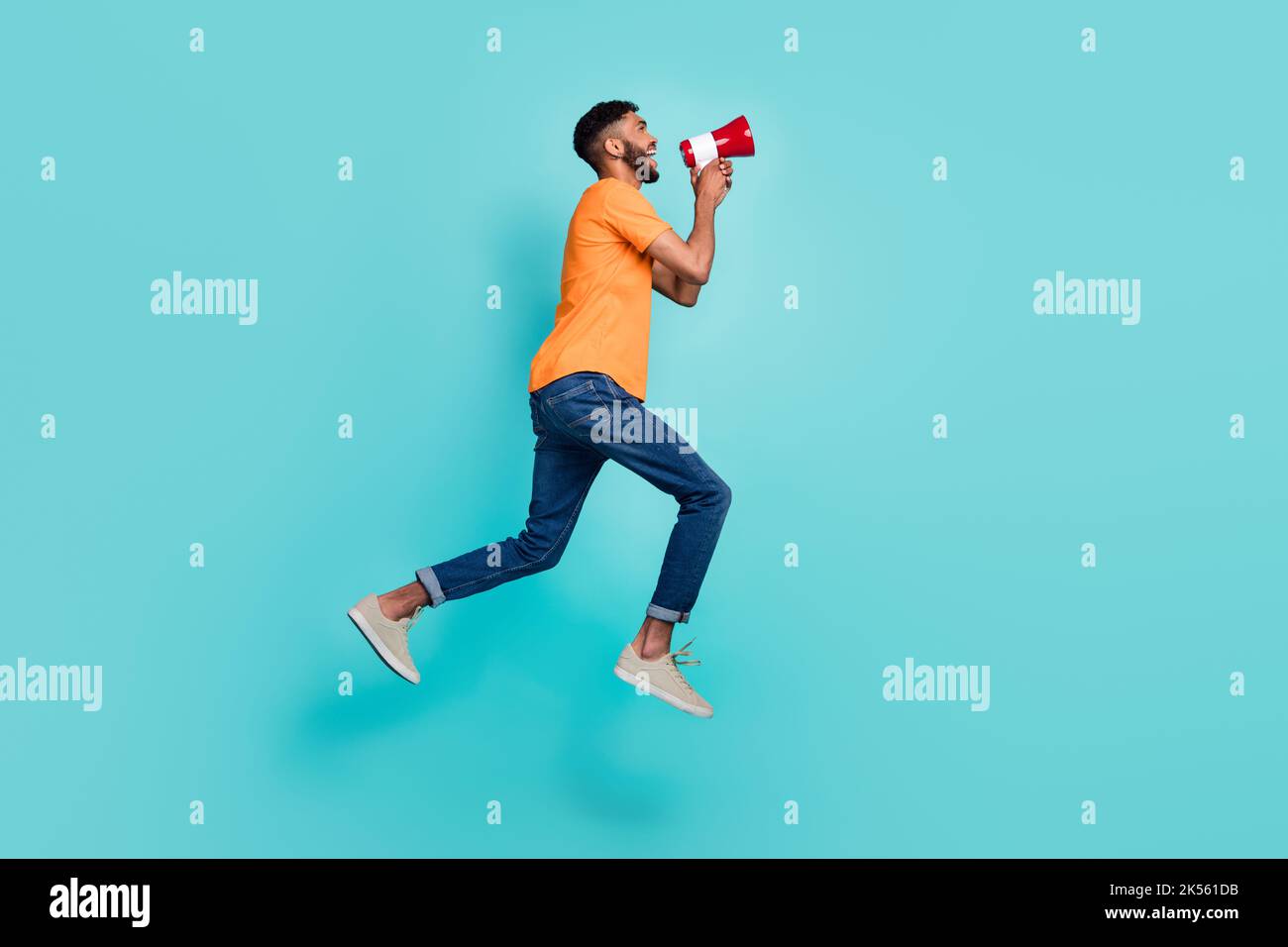 Full size profile portrait of excited person jump run hold loudspeaker ...