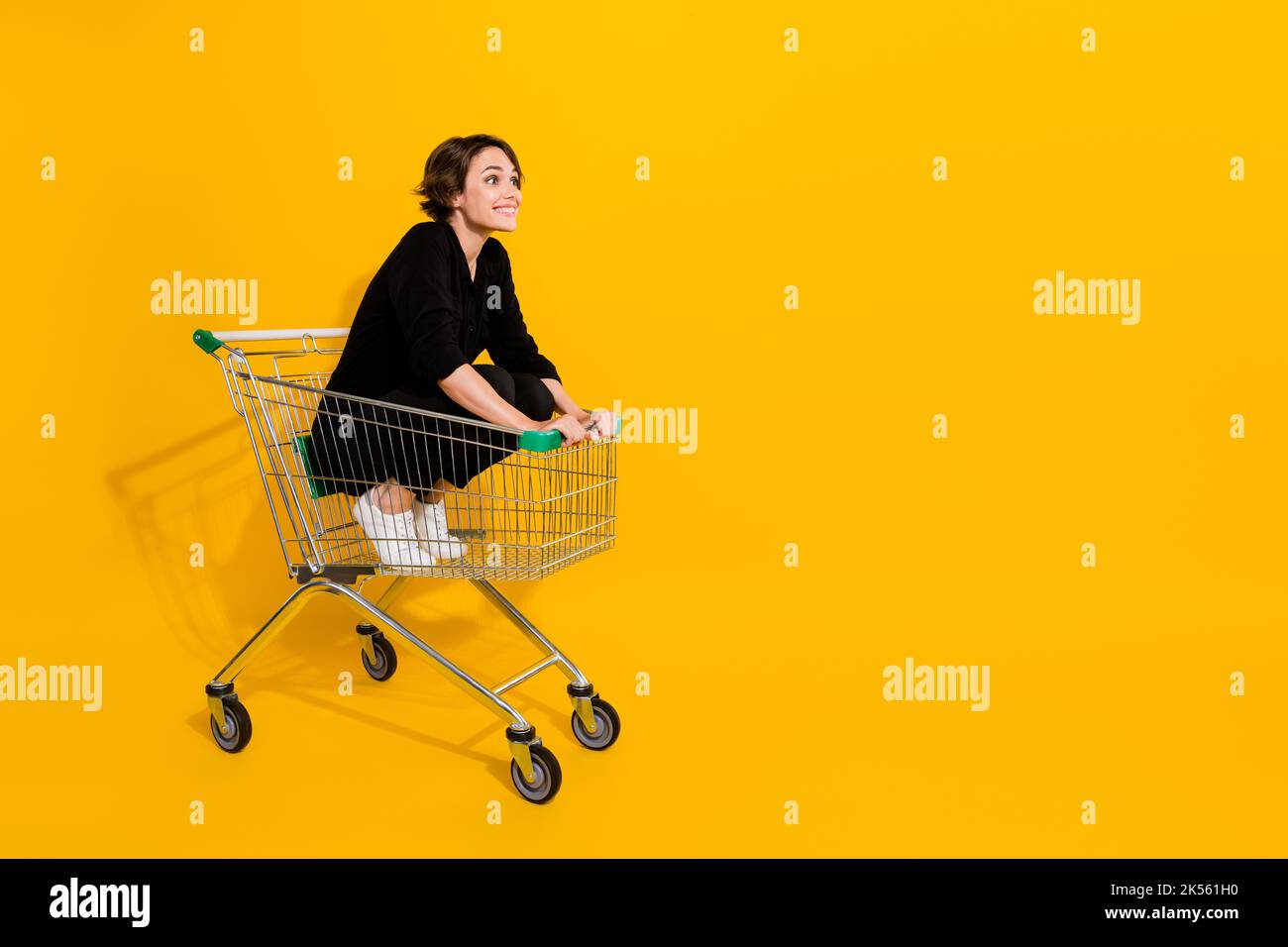 Photo of excited impressed lady wear black shirt riding shopping tray ...