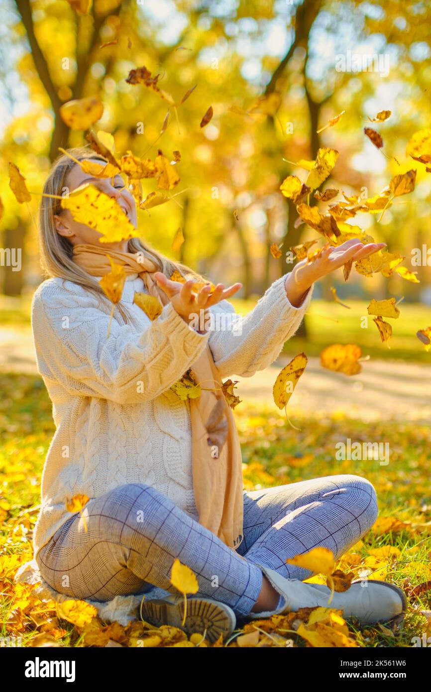 young woman throw leaves in a park in autumn Stock Photo - Alamy