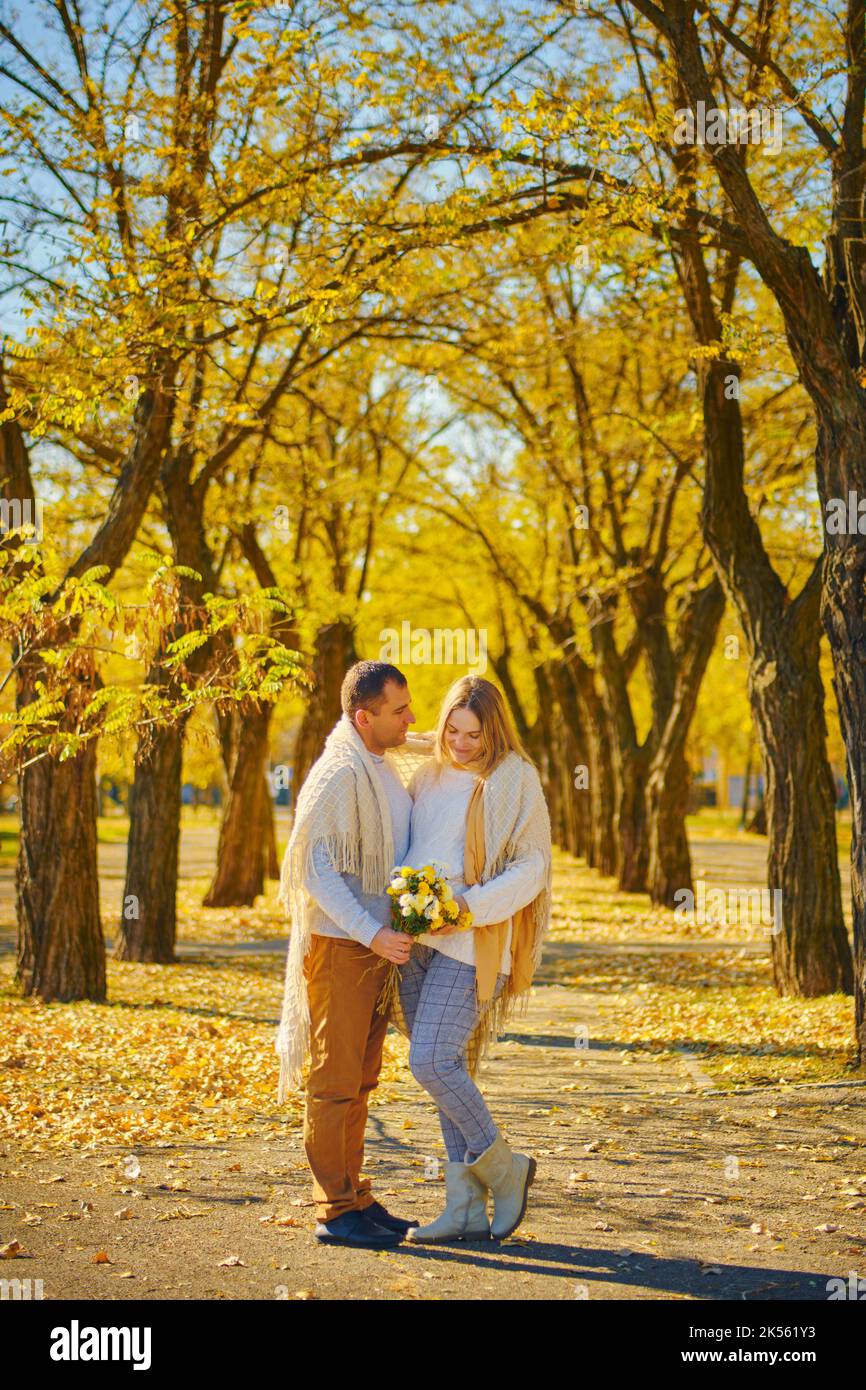 Pregnant woman and man at sunny warm autumn park Stock Photo - Alamy