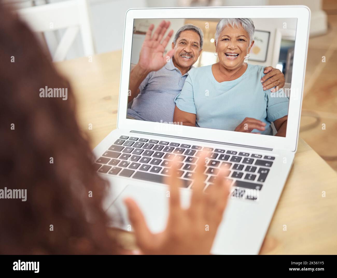 Senior couple, video call on laptop and talking to family, wave hello ...