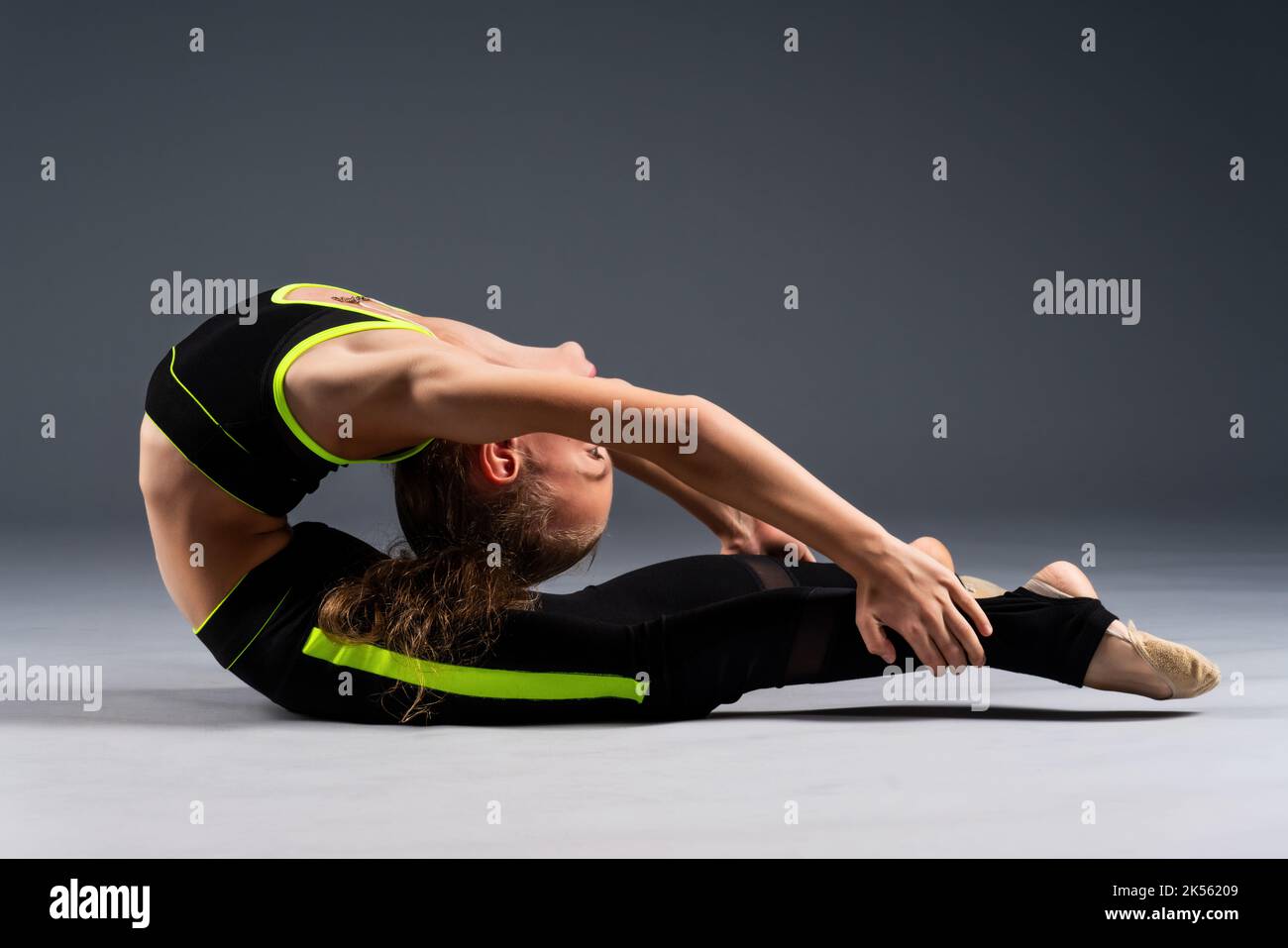 Young gymnast. A flexible teenage girl in a tracksuit is engaged in ...