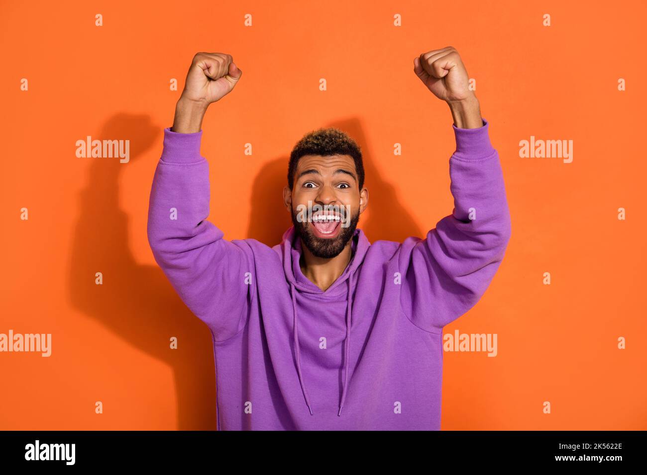 Photo of astonished nice boy man raise hands up rejoice victory ...