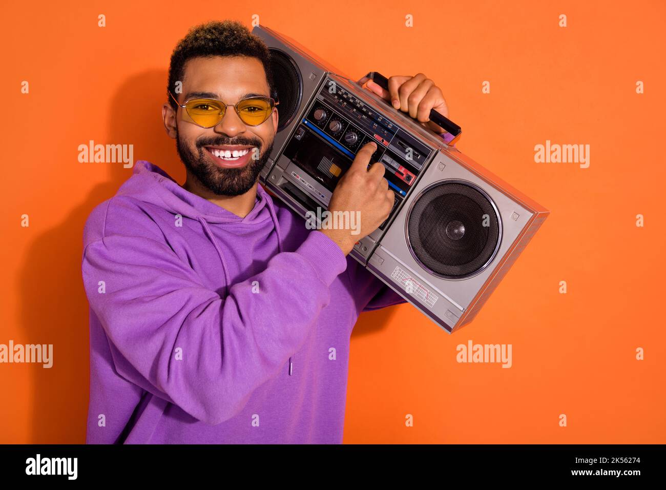 Portrait of cheerful excited guy carry boombox turn on song have good ...