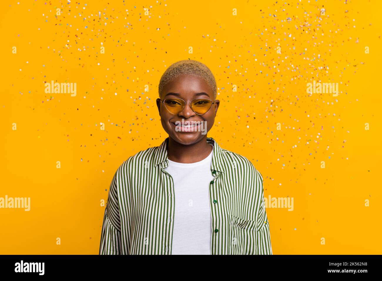 Photo of satisfied friendly lady toothy smile flying confetti have good ...