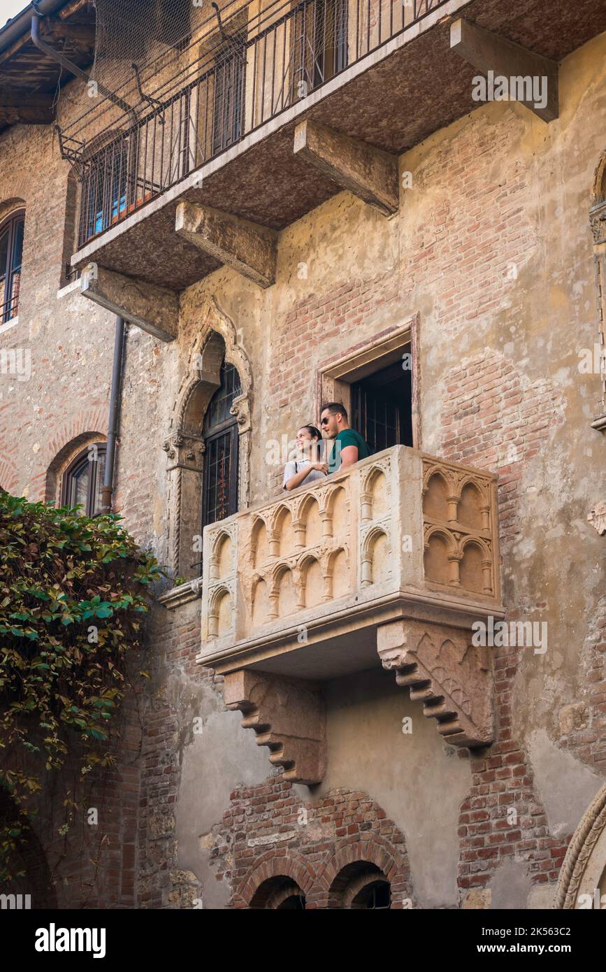 Verona balcony, view of a young couple standing on the balcony of the ...