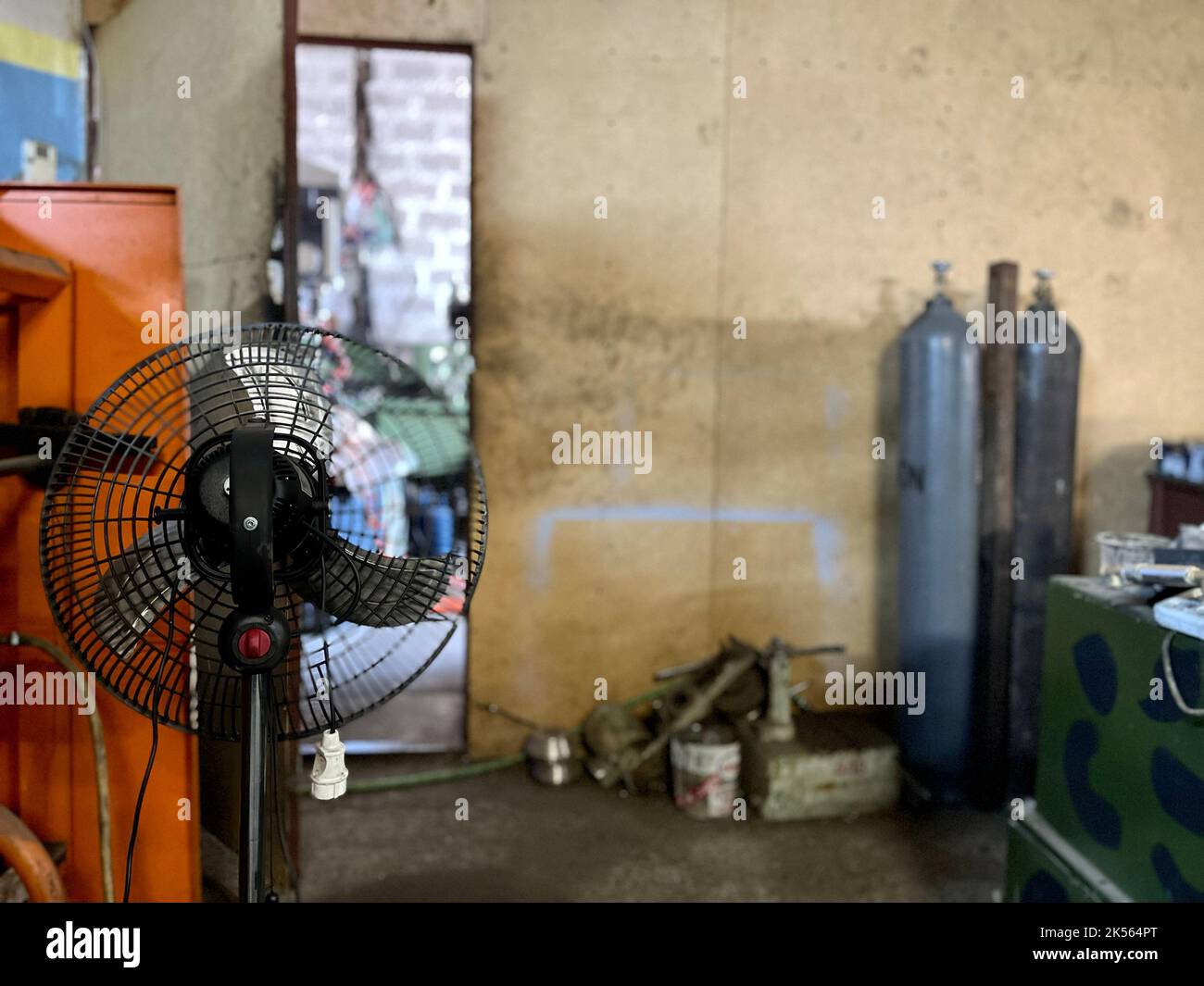 A closeup of a fan inside an old room with oxygen tubes and mirror in ...