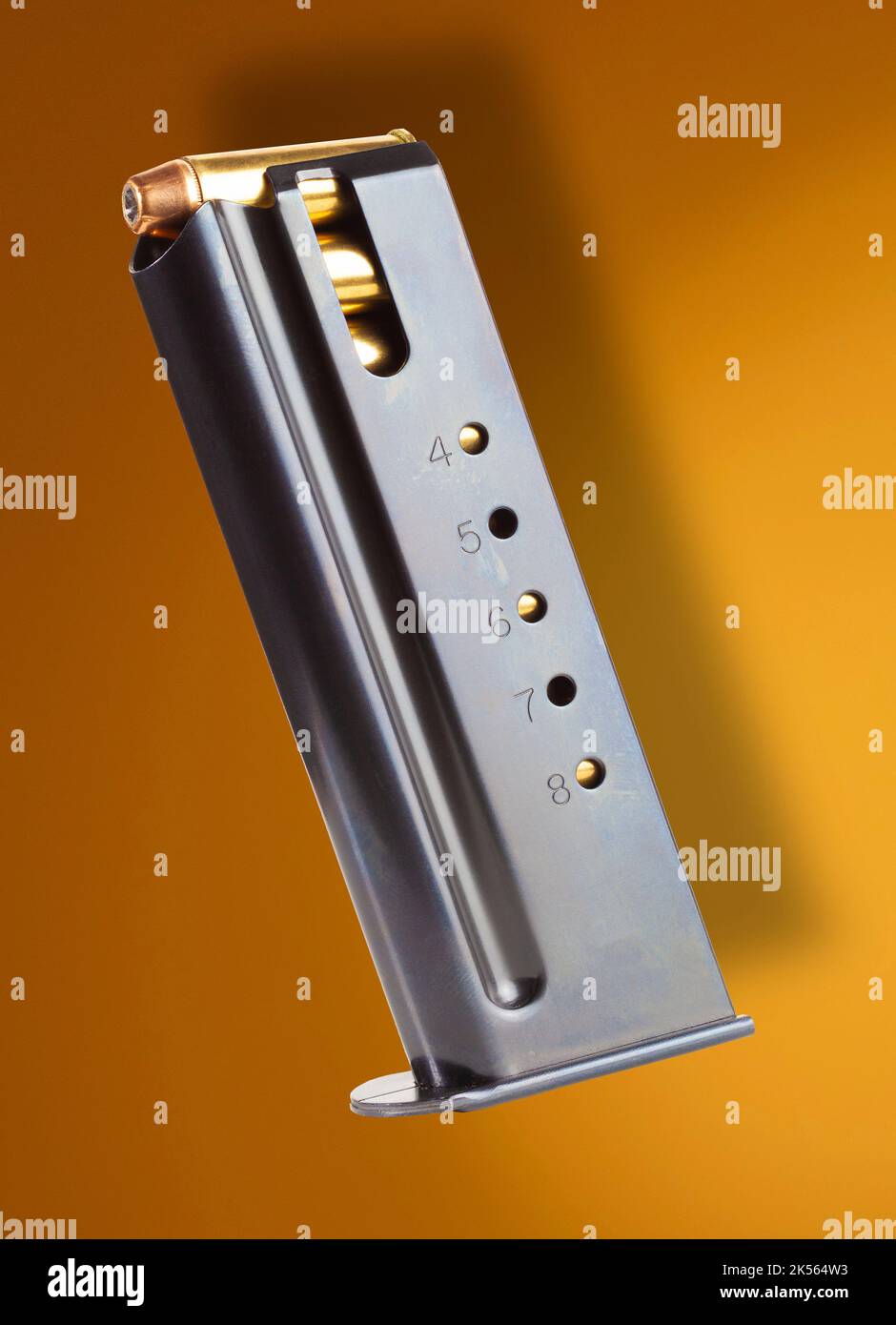 Fully loaded firearm magazine on an orange background with shadow ...