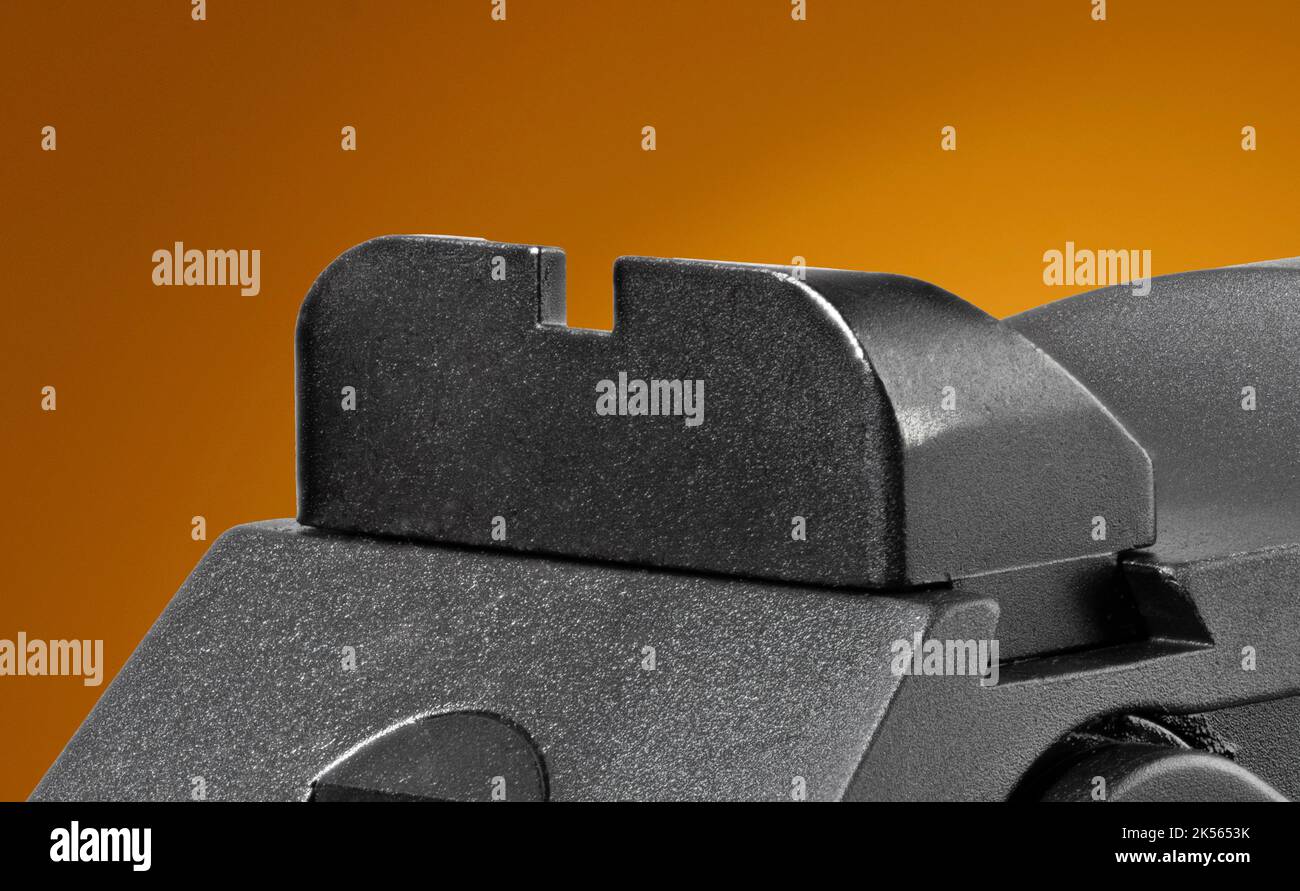 Semi auto pistol rear sight on a brown background Stock Photo - Alamy