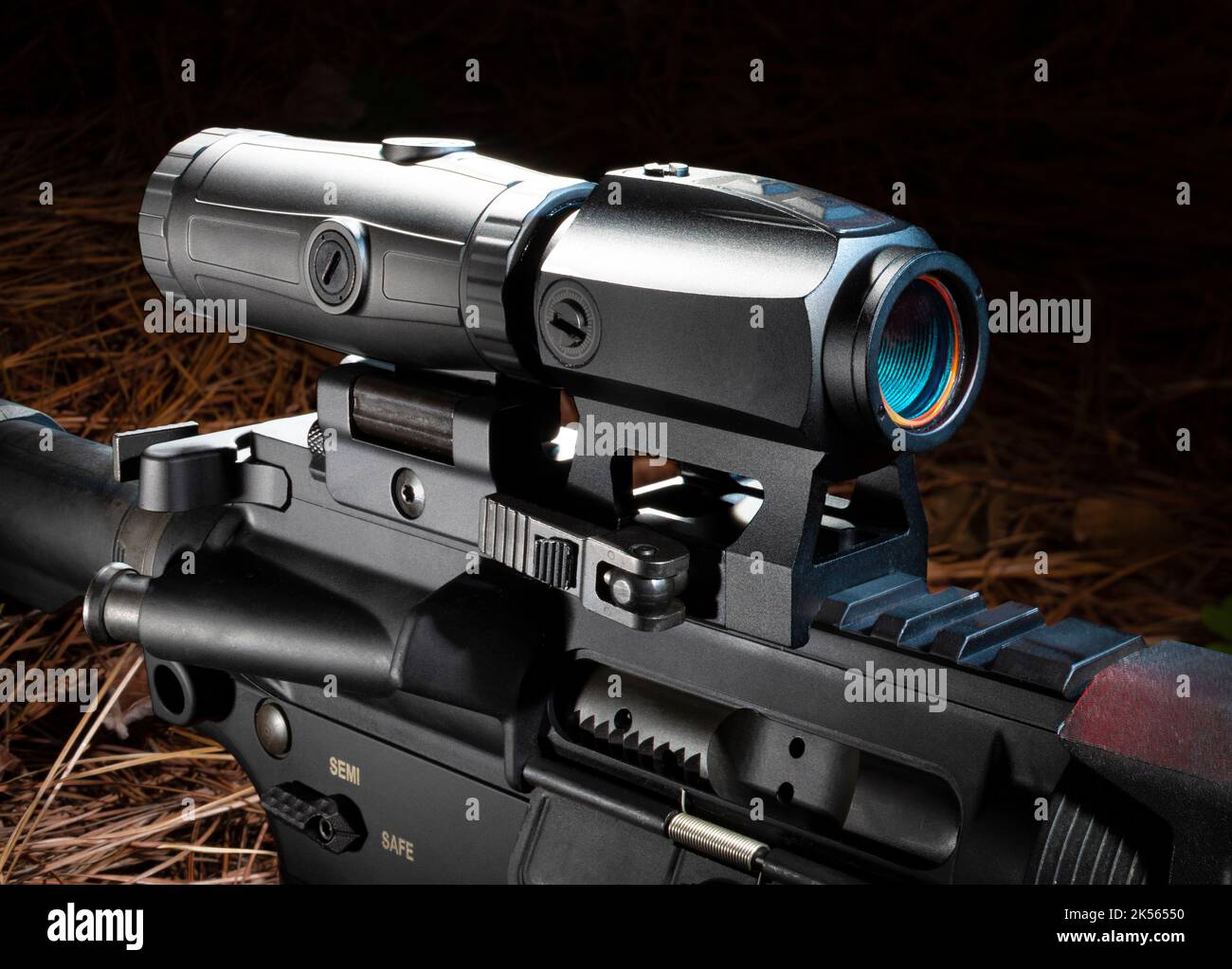 Magnifier behind a red dot sight on a modern sporting rifle outside ...