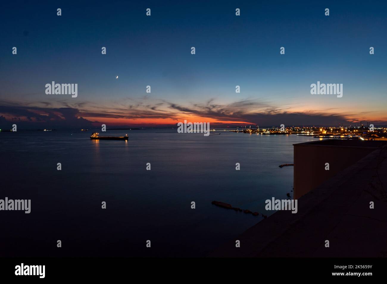 Summer sunset from 14th floor in front of Taranto's bay and harbour ...