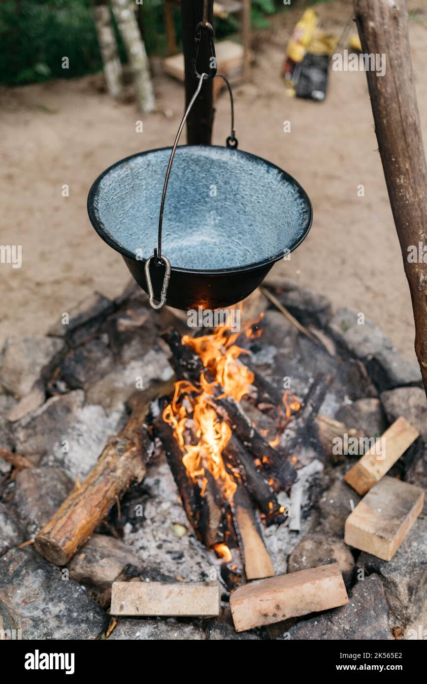 cooking food over a fire in a pot Stock Photo - Alamy
