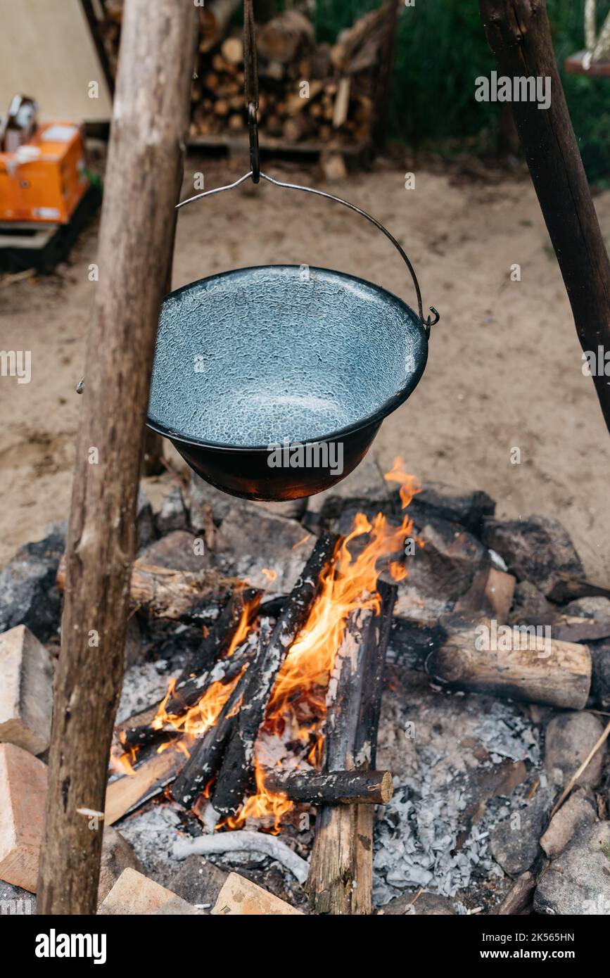 cooking food over a fire in a pot Stock Photo - Alamy