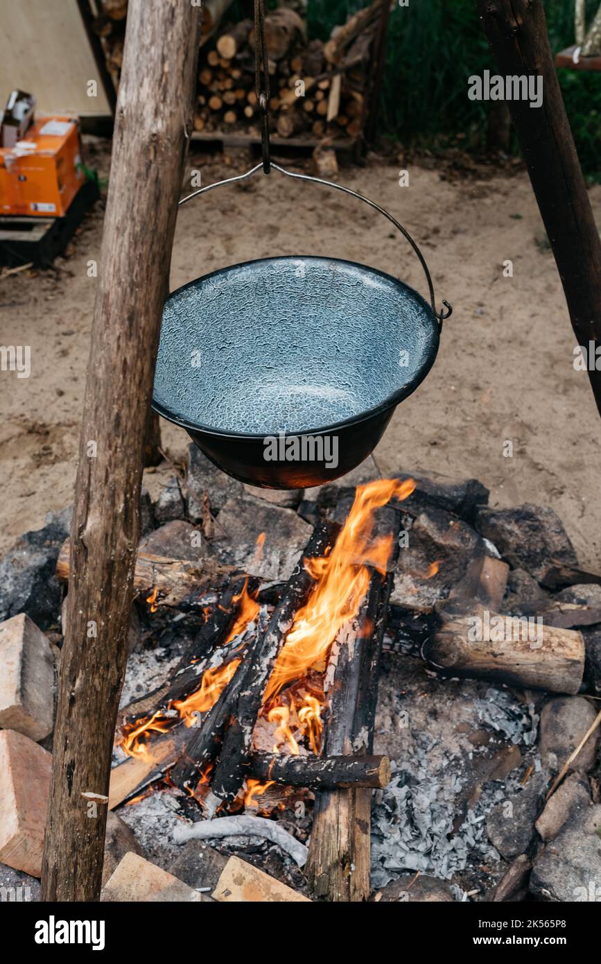 cooking food over a fire in a pot Stock Photo - Alamy