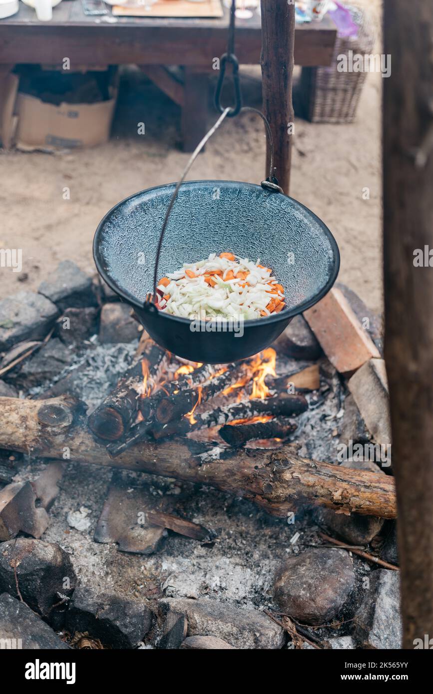 cooking food over a fire in a pot Stock Photo - Alamy