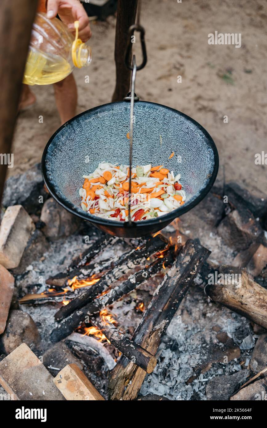 cooking food over a fire in a pot Stock Photo - Alamy