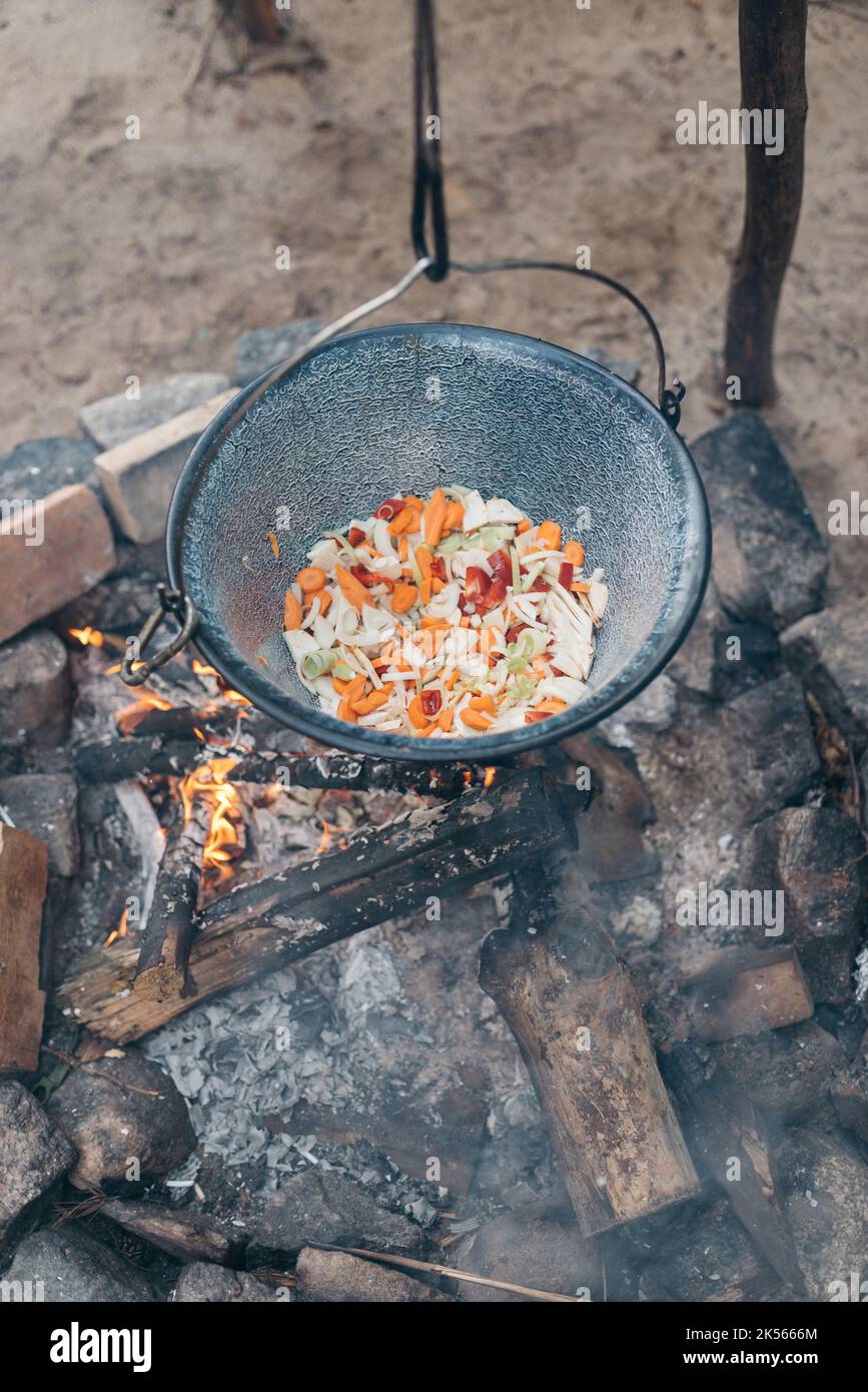 cooking food over a fire in a pot Stock Photo - Alamy