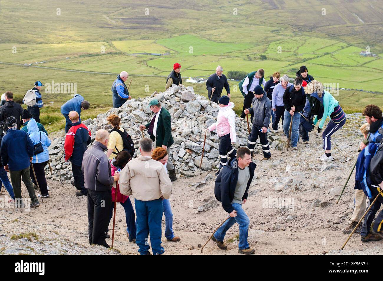 People walk around a stone pile 7 times on Croagh Patrick on Reek ...