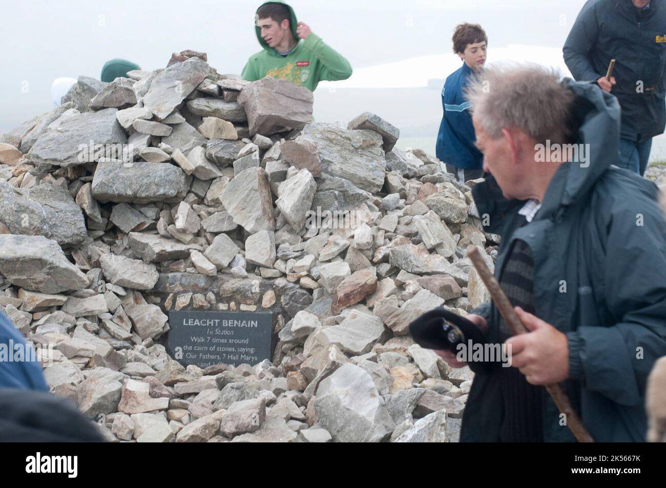 People walk around a stone pile 7 times on Croagh Patrick on Reek ...