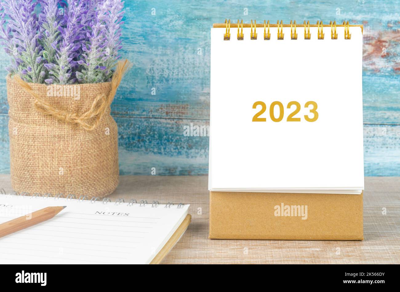 2023 Desk calender with Note Book on wooden background Stock Photo - Alamy