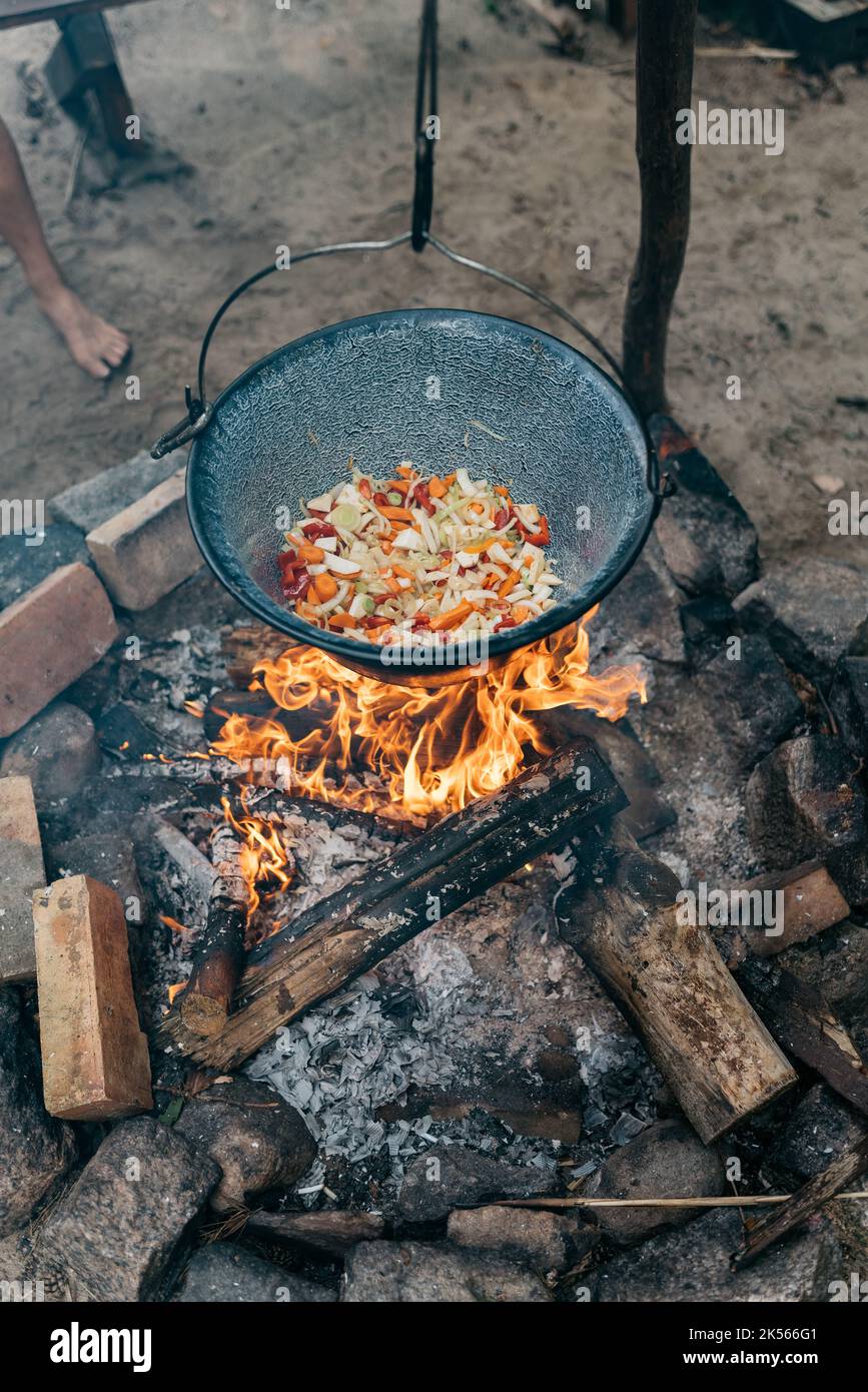 cooking food over a fire in a pot Stock Photo - Alamy