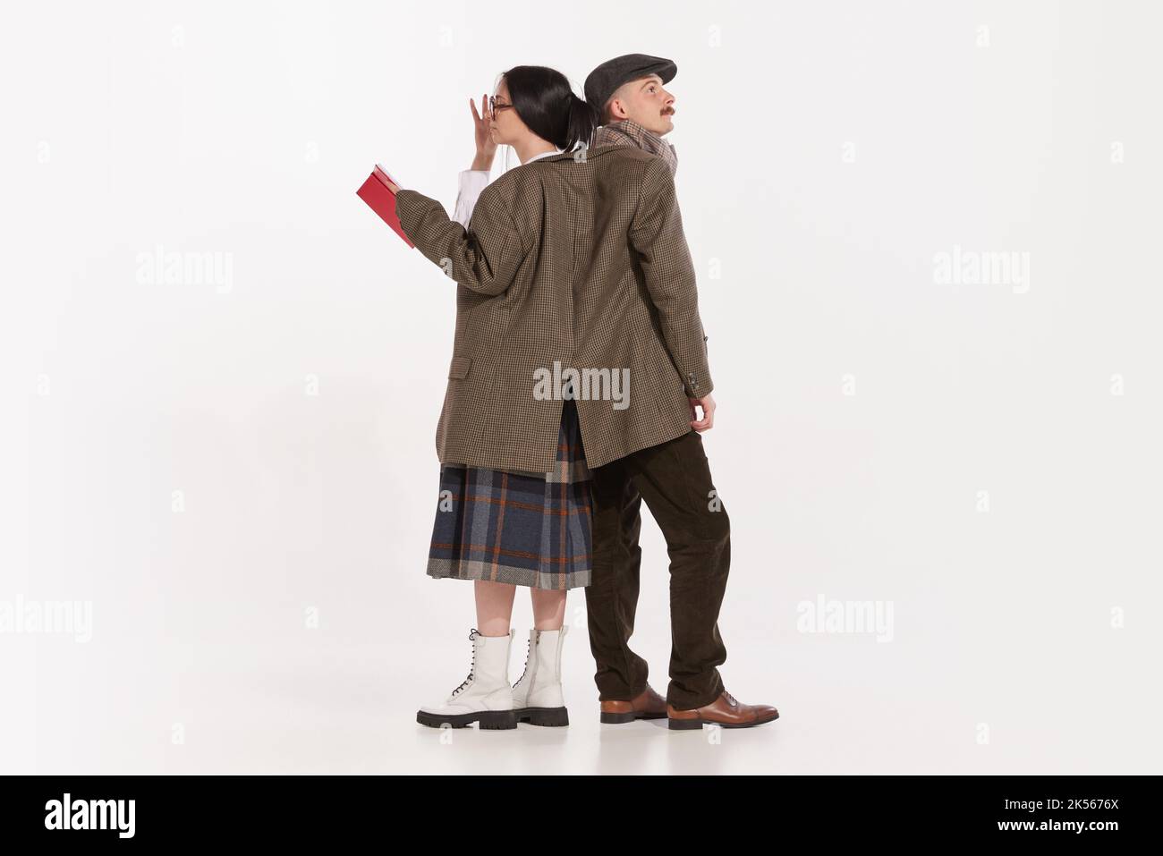 Portrait of young man and woman wearing the same jacket isolated over ...