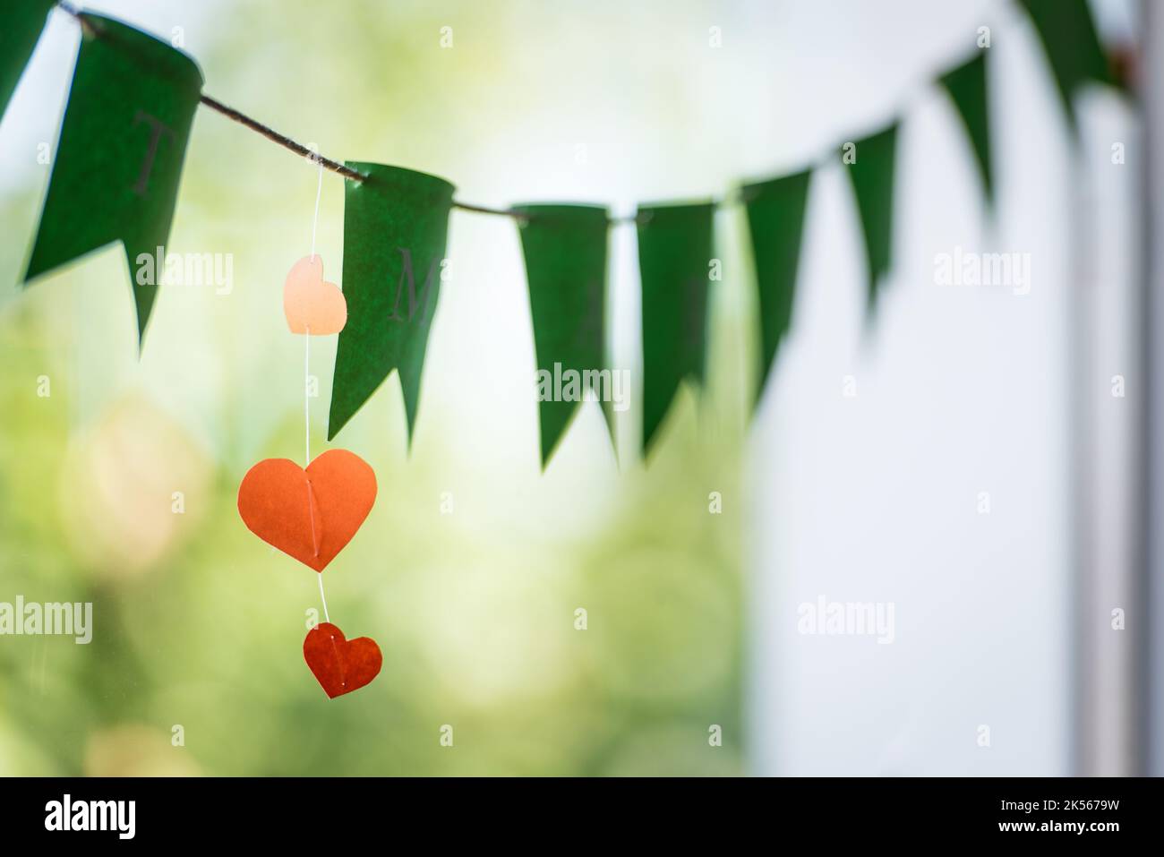 The green bunting decoration with red hearts Stock Photo - Alamy